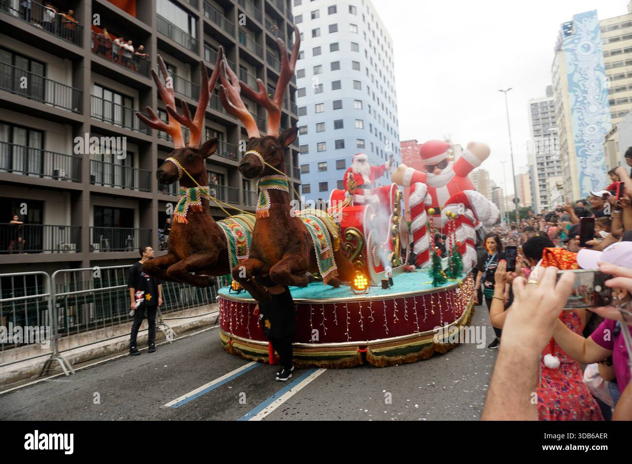 People gather to watch a Christmas parade in Sao Paulo, Brazil, 13 ...