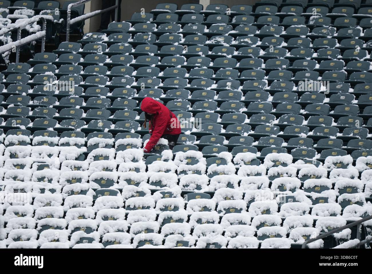 Snow is cleared from seats before an NFL football game between the ...