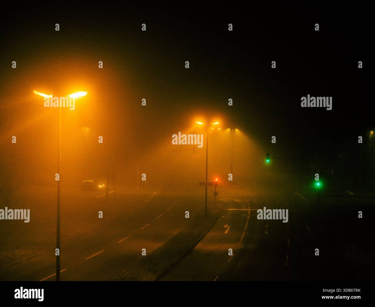 Foggy Night Street With Orange Glow From Streetlights And Green Traffic ...
