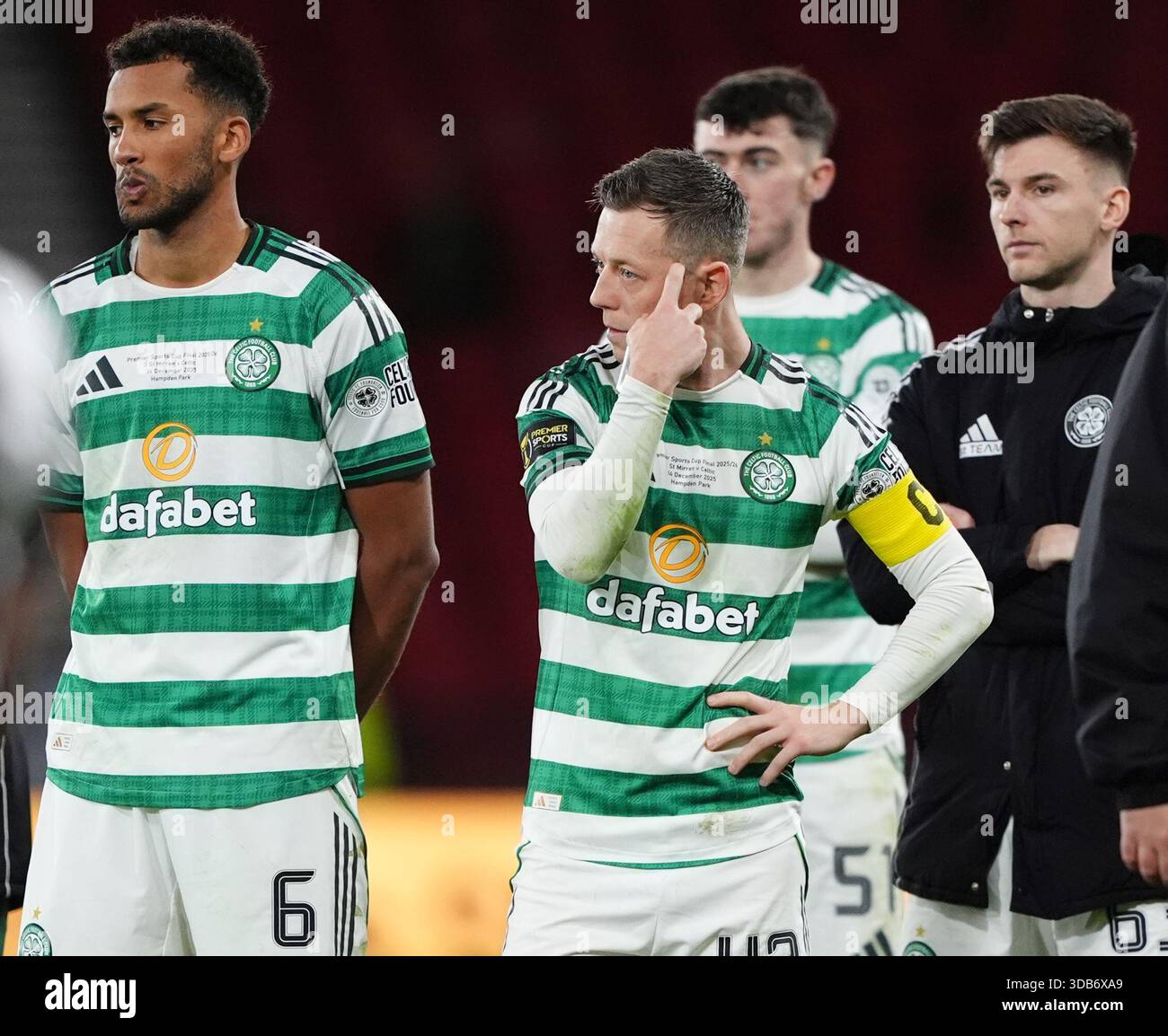 Celtic's Callum McGregor (centre) looks on as St Mirren lift the trophy ...