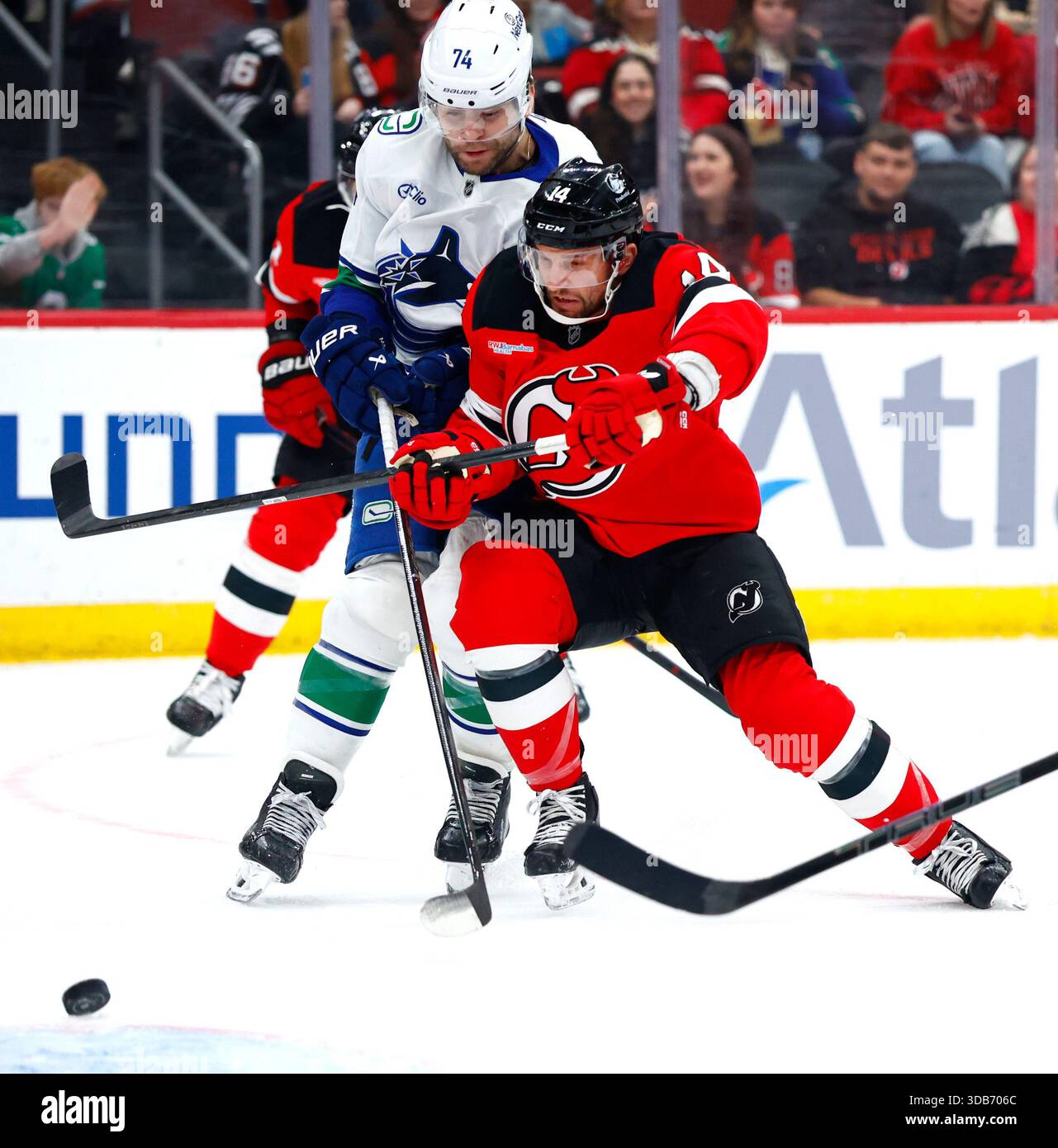 New Jersey Devils center Luke Glendening, right, and Vancouver Canucks ...