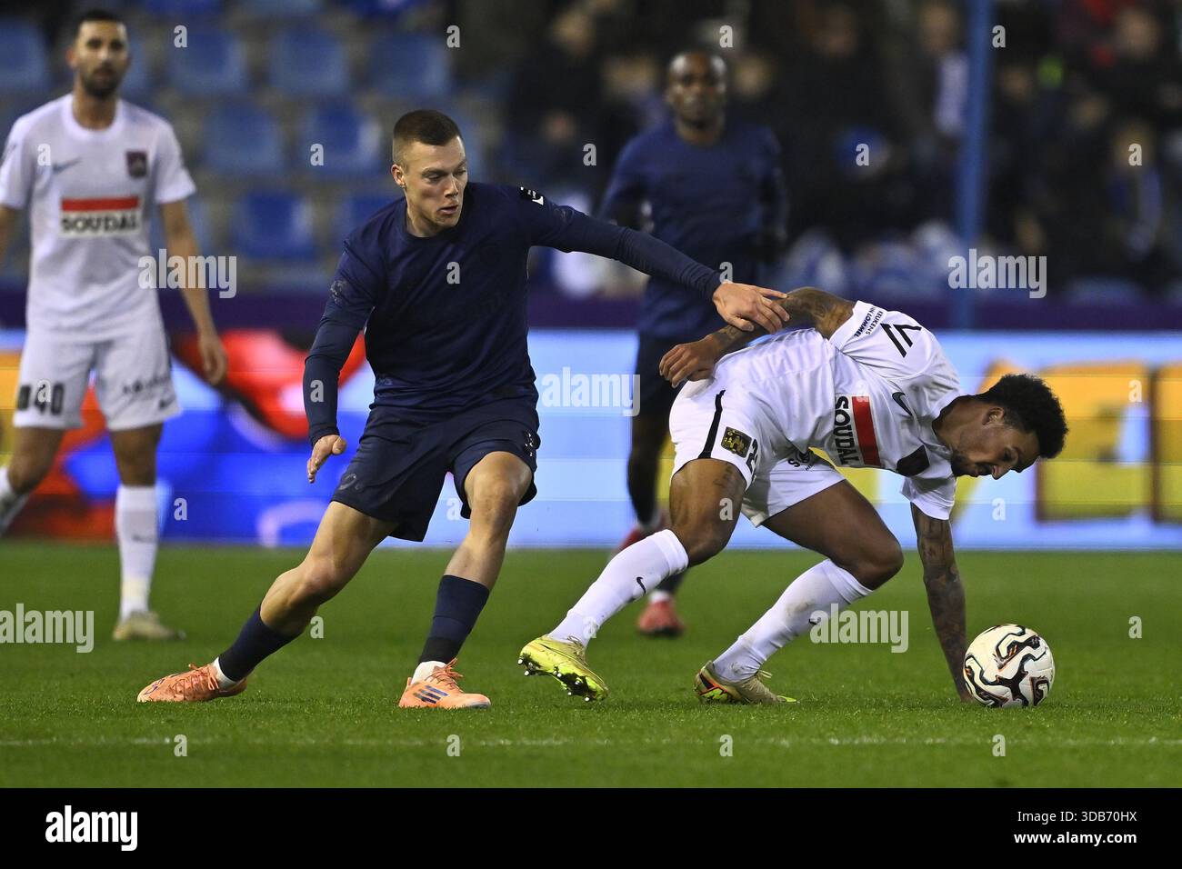 Genk's Daan Heymans and Westerlo's Bryan Reynolds fight for the ball ...