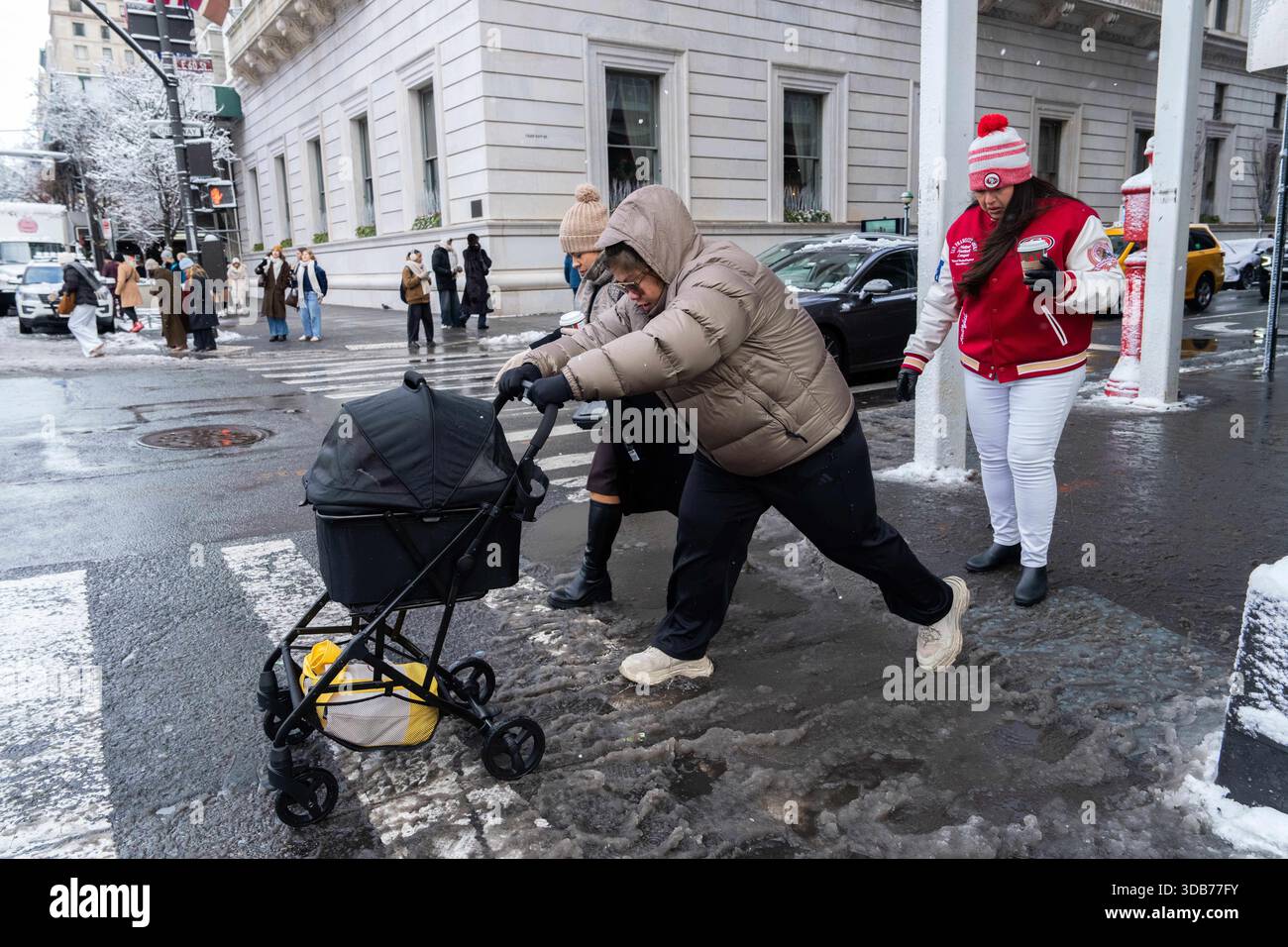 A person navigates a puddle of slush after snow fall, Sunday, Dec. 14 ...