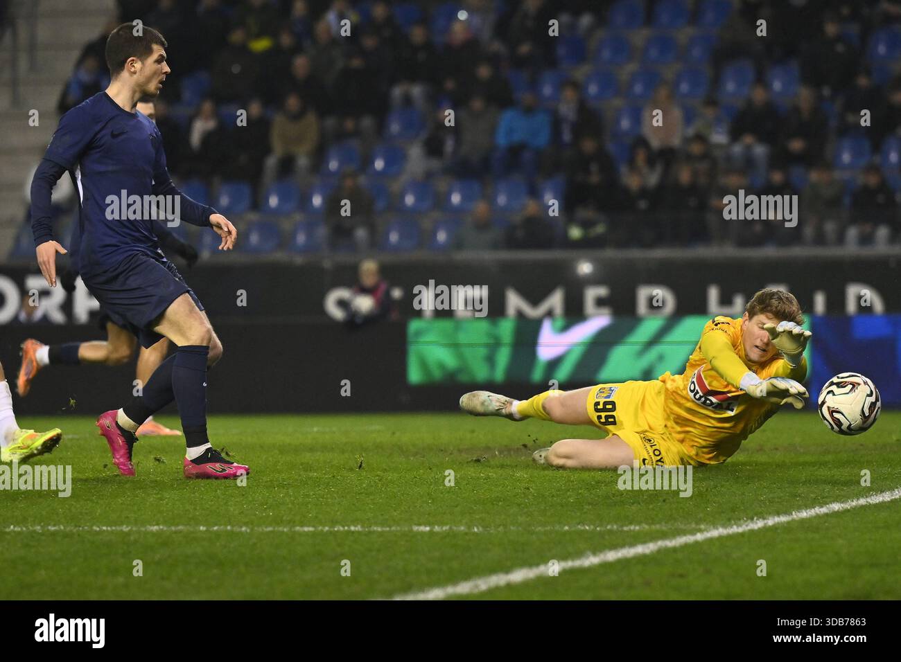Genk's Jarne Steuckers and Westerlo's goalkeeper Andreas Jungdal fight ...