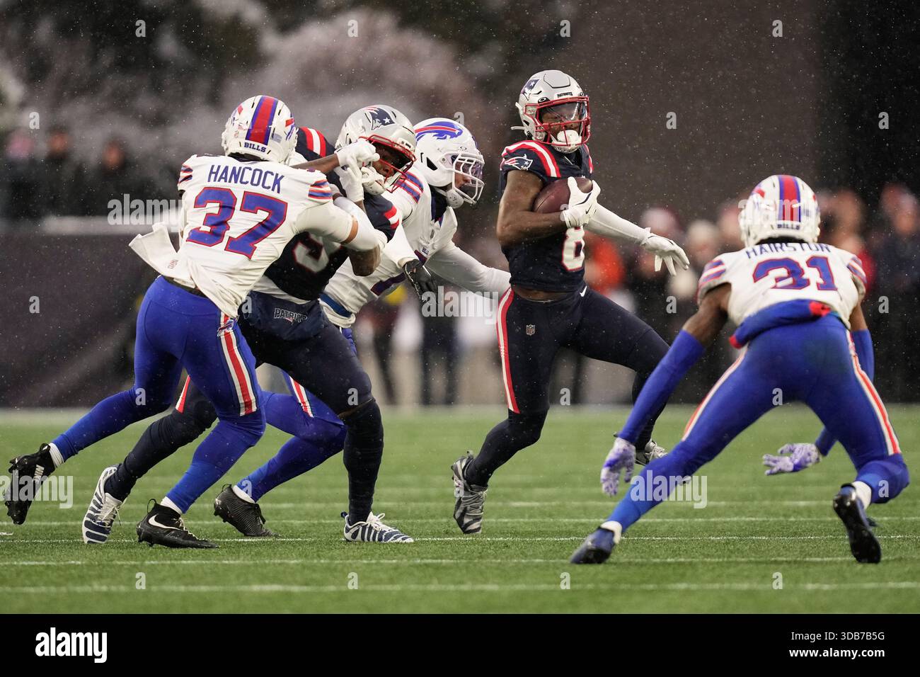 New England Patriots wide receiver Stefon Diggs, middle right, runs ...