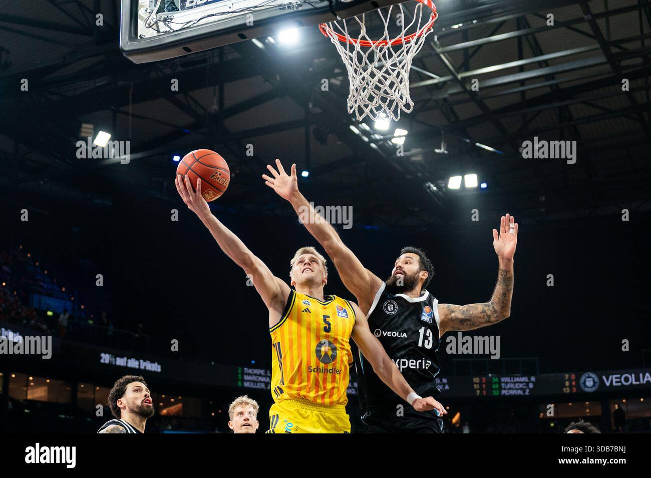 Sam Griesel (ALBA Berlin, #05) performing a layup against Martin ...