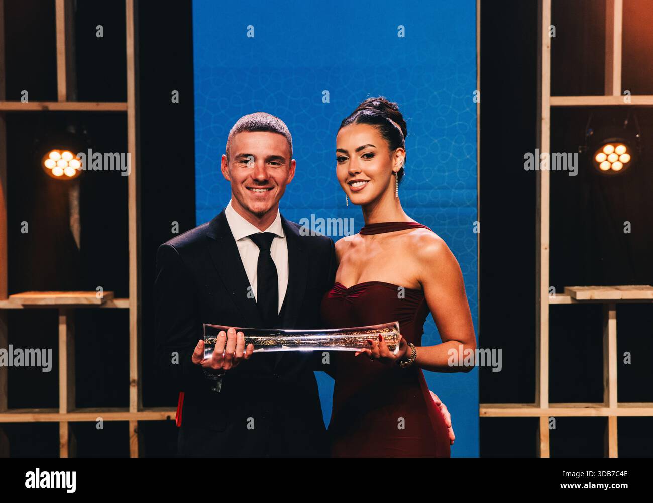 Remco Evenepoel and his wife Oumaima Oumi Rayane pose with the trophy ...