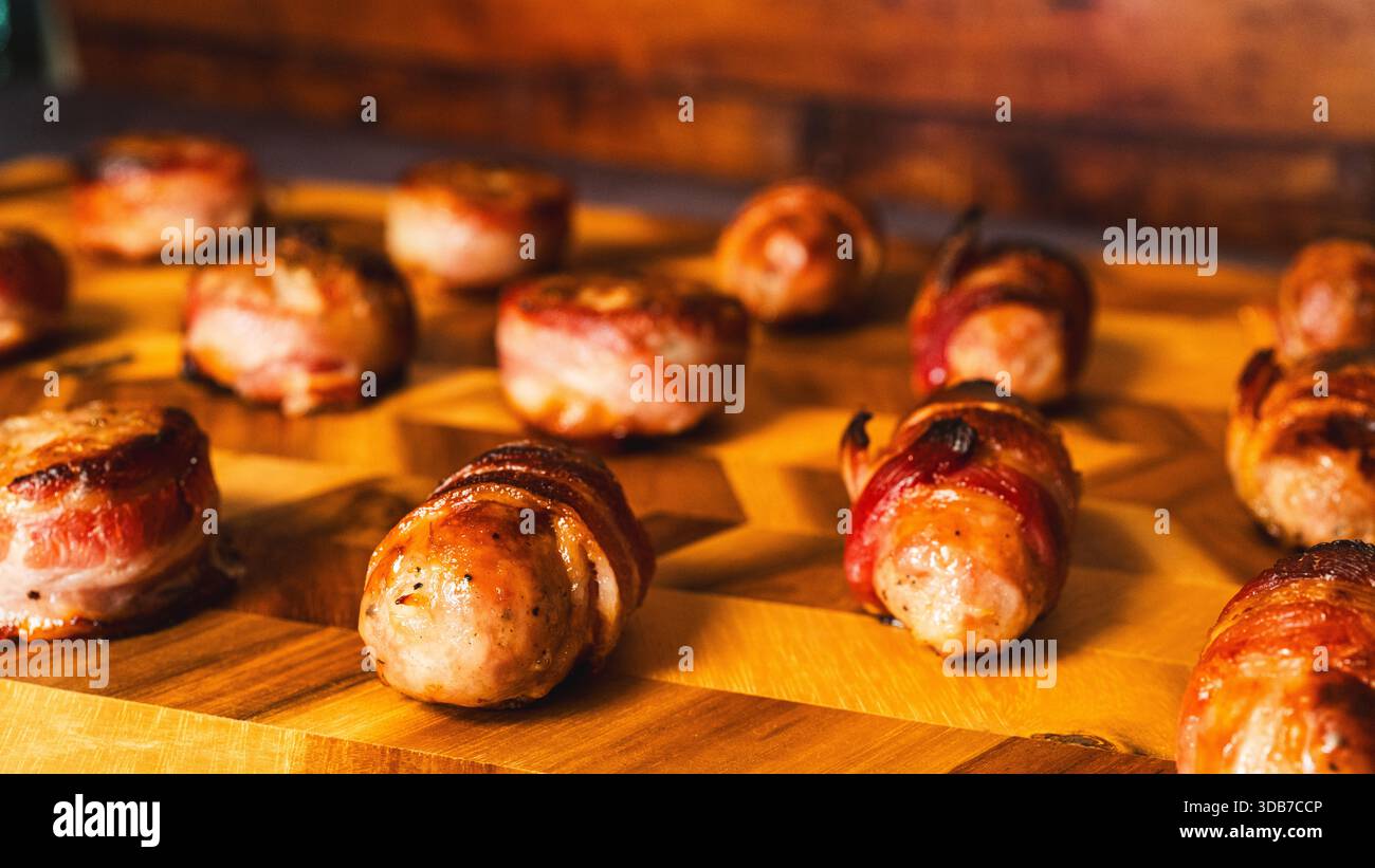Festive board with pigs in blankets and bacon-wrapped pork snacks ...