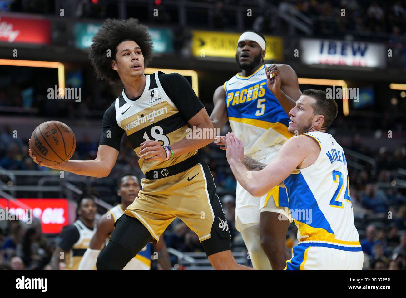Washington Wizards forward Kyshawn George, left, passes around Indiana ...