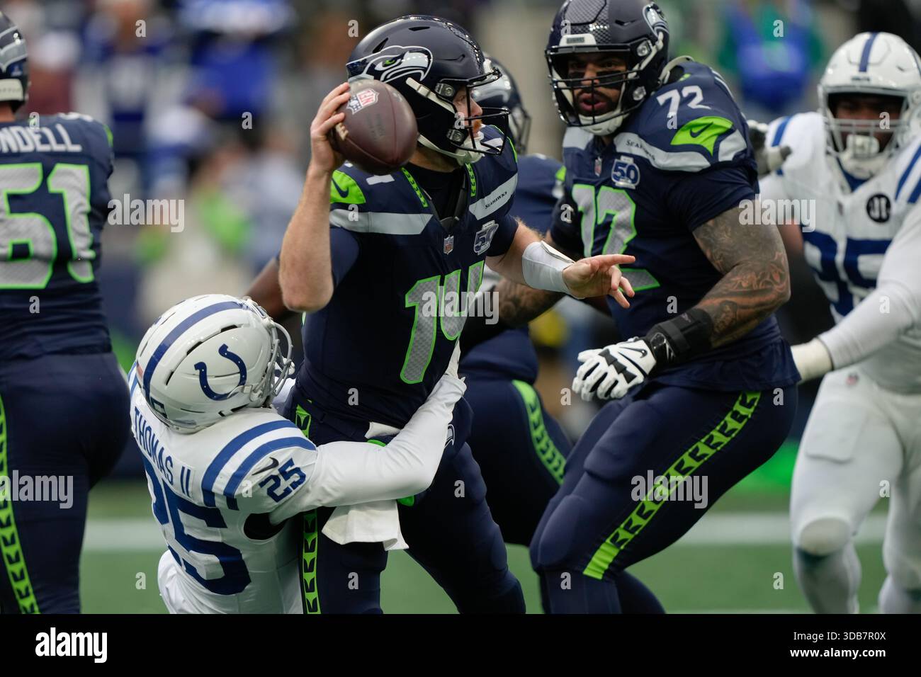 Seattle Seahawks quarterback Sam Darnold (14) tries to throw under ...