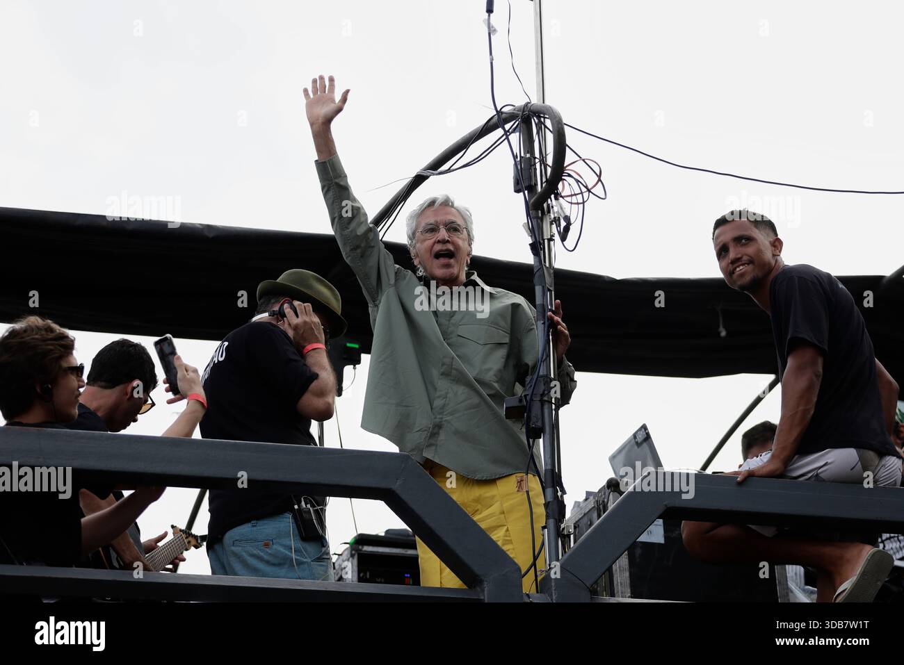 Singer Caetano Veloso greets the audience upon arriving at a protest ...