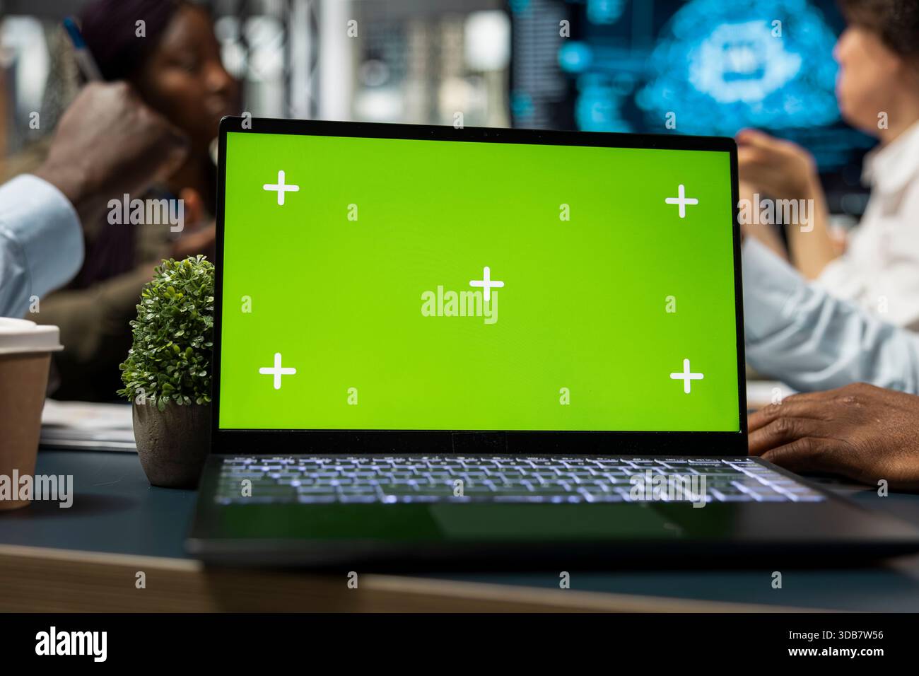 Green screen laptop used by AI company programmers doing brainstorming ...