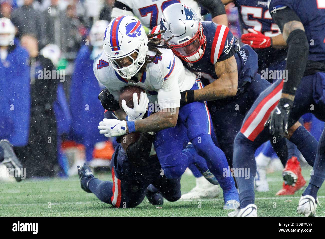 Buffalo Bills running back James Cook III (4) is tackled by New England ...
