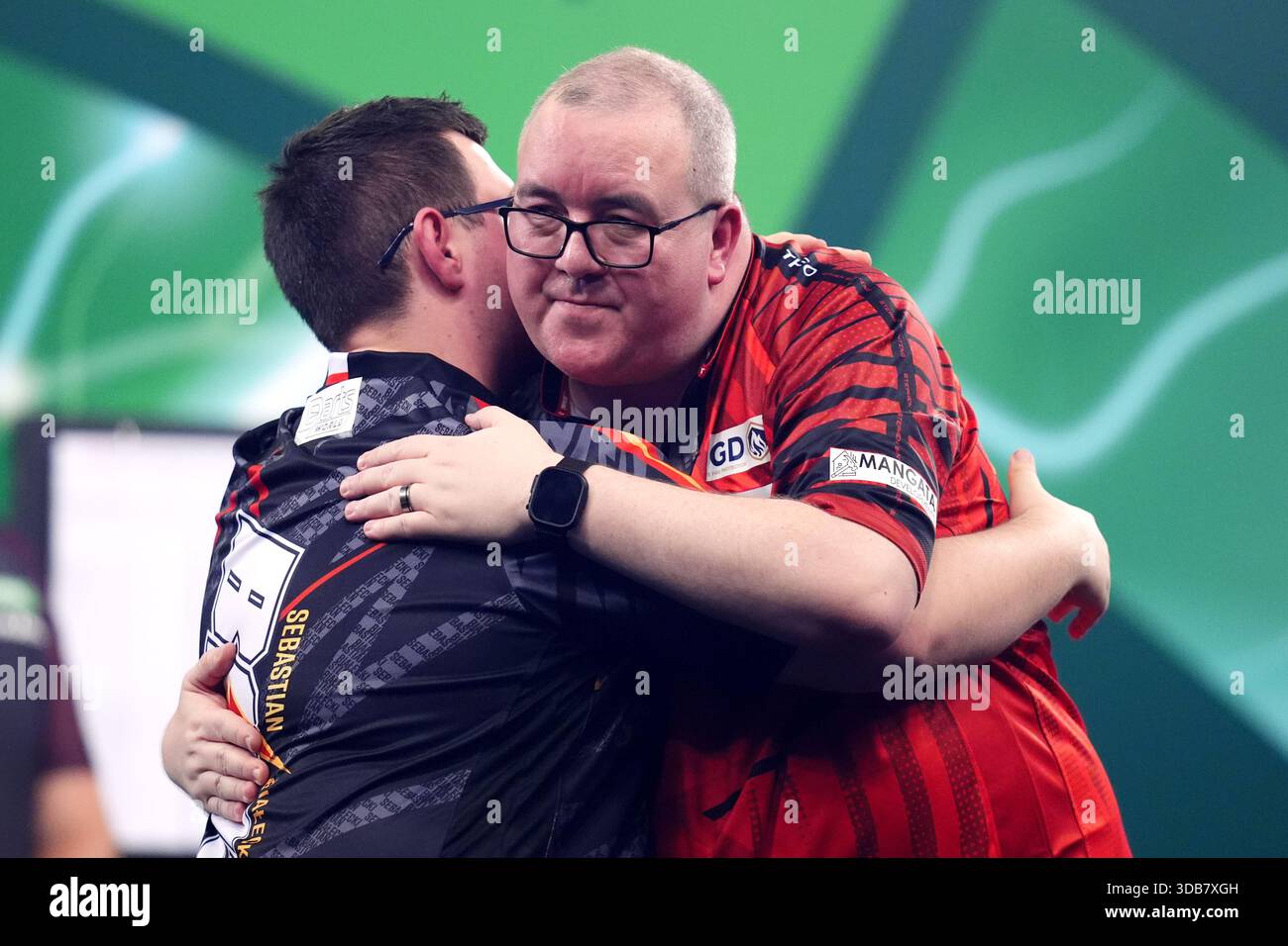Stephen Bunting (right) celebrates defeating Sebastian Bialecki on day ...