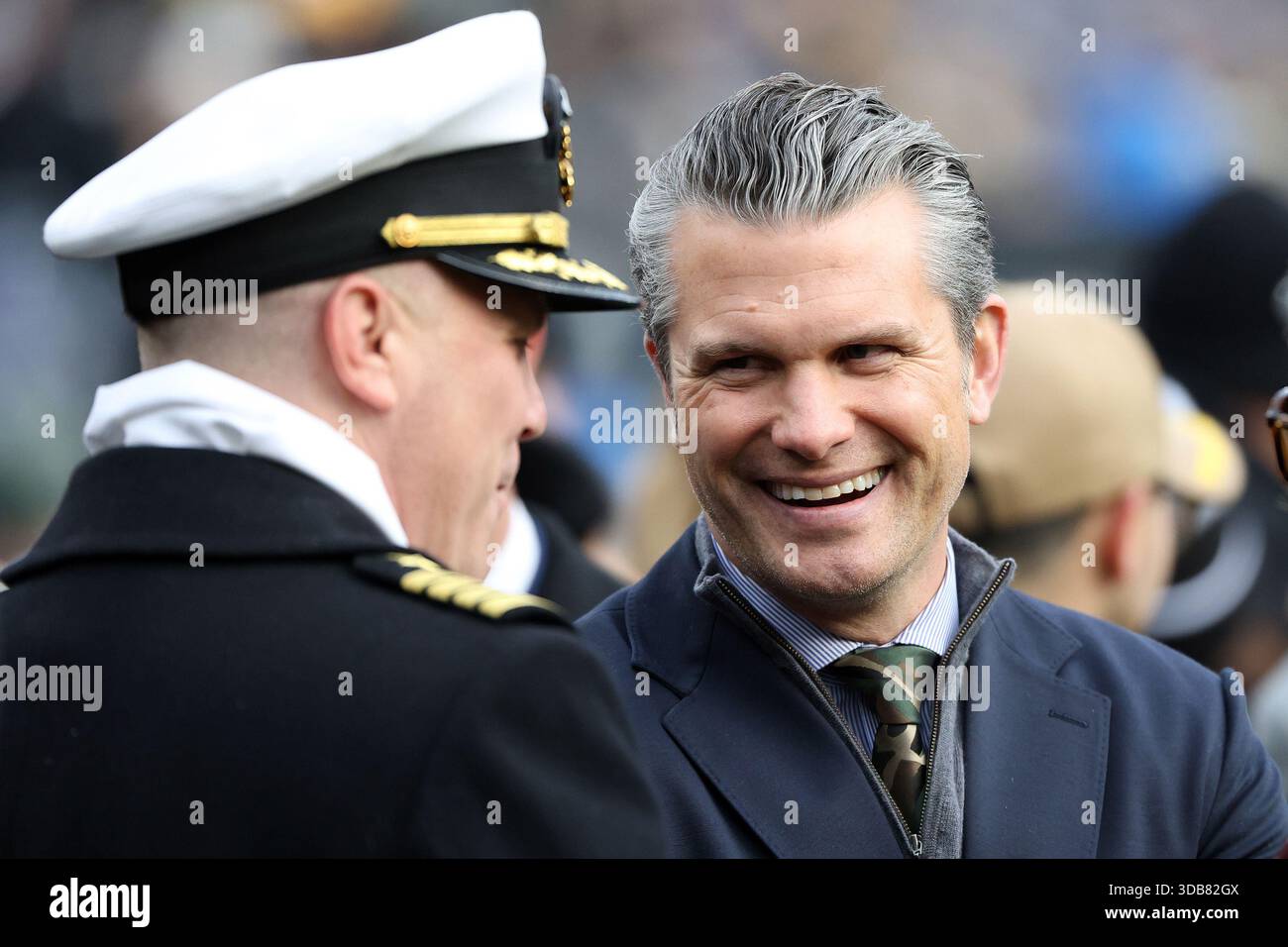 United States Secretary of War Pete Hegseth looks on before an NCAA ...