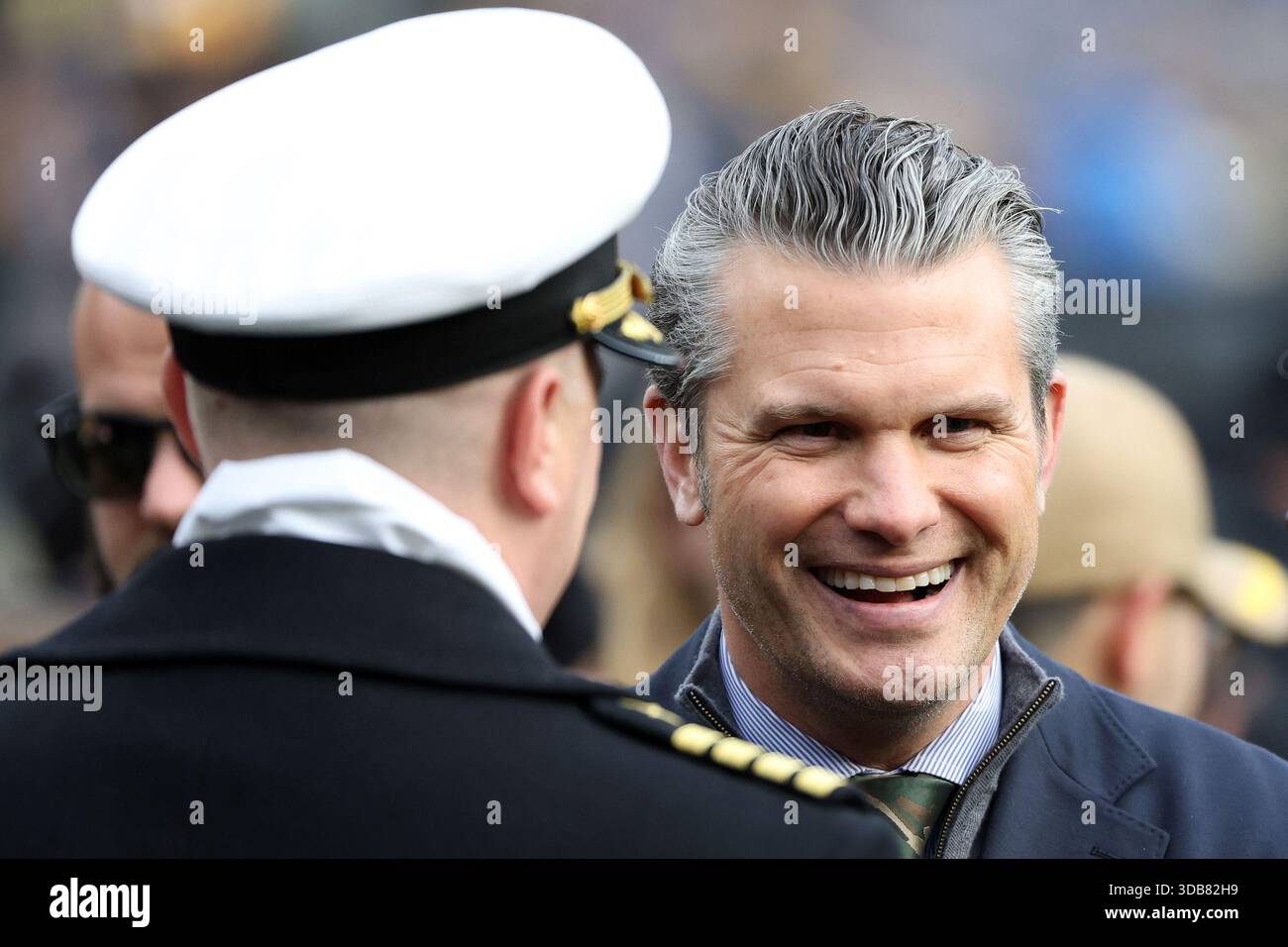 United States Secretary of War Pete Hegseth looks on before an NCAA ...