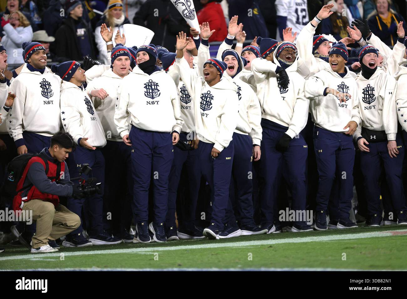 Navy players celebrate on the sideline during the second half of an ...