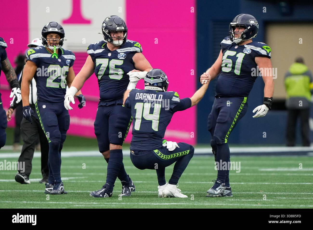 Seattle Seahawks center Jalen Sundell (61) helps quarterback Sam ...