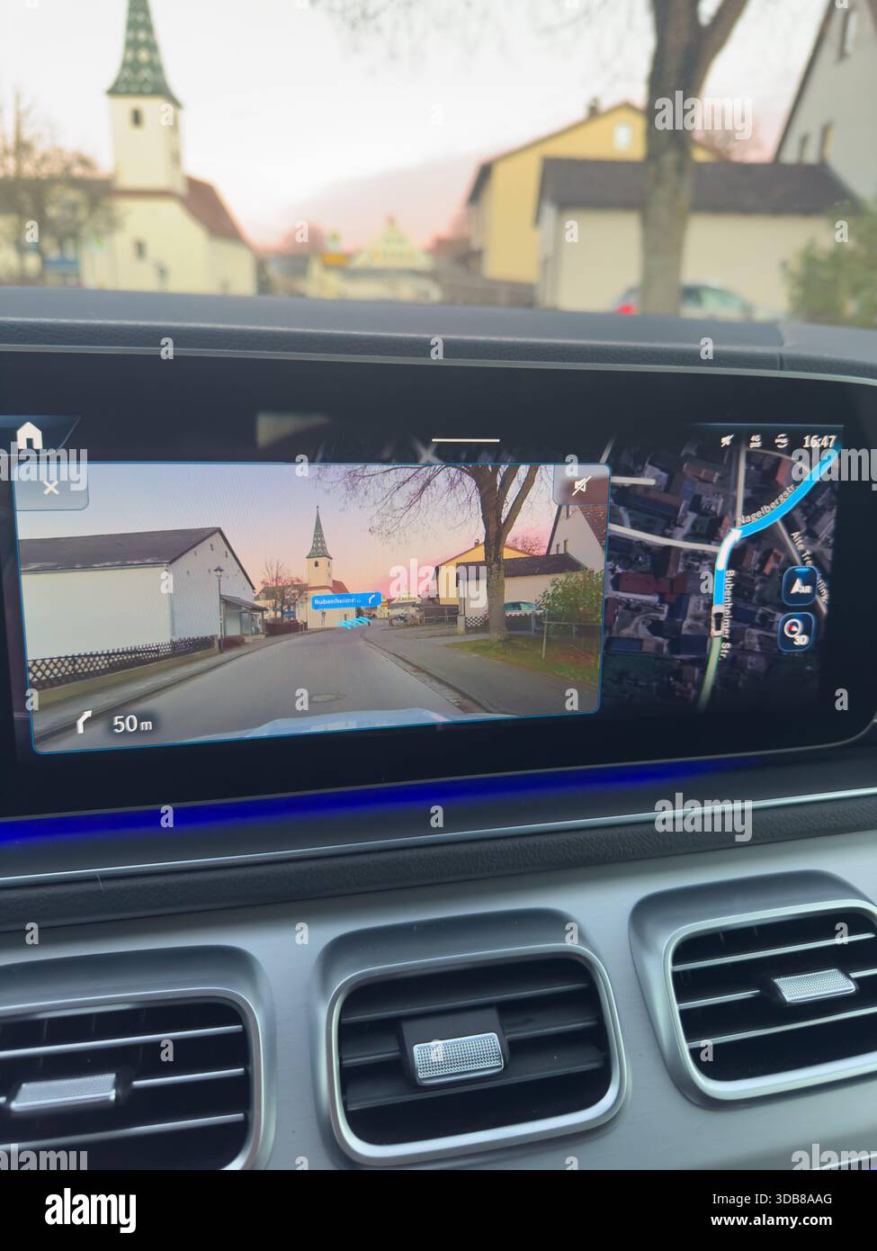 Car dashboard displaying a split screen with augmented reality gps ...