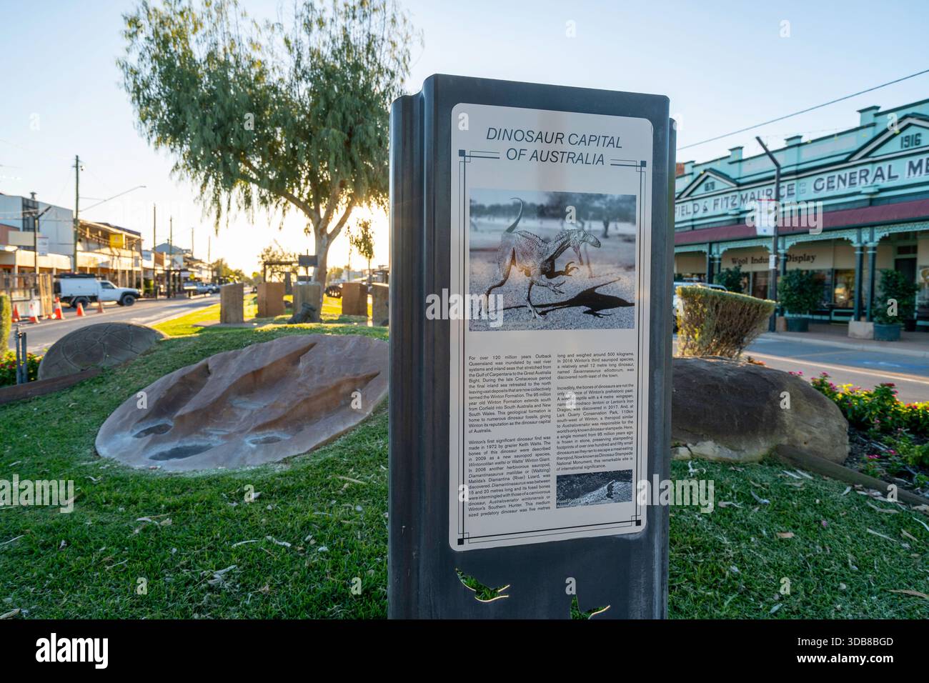 Information sign and concrete dinosaur footprint in parkland in the ...