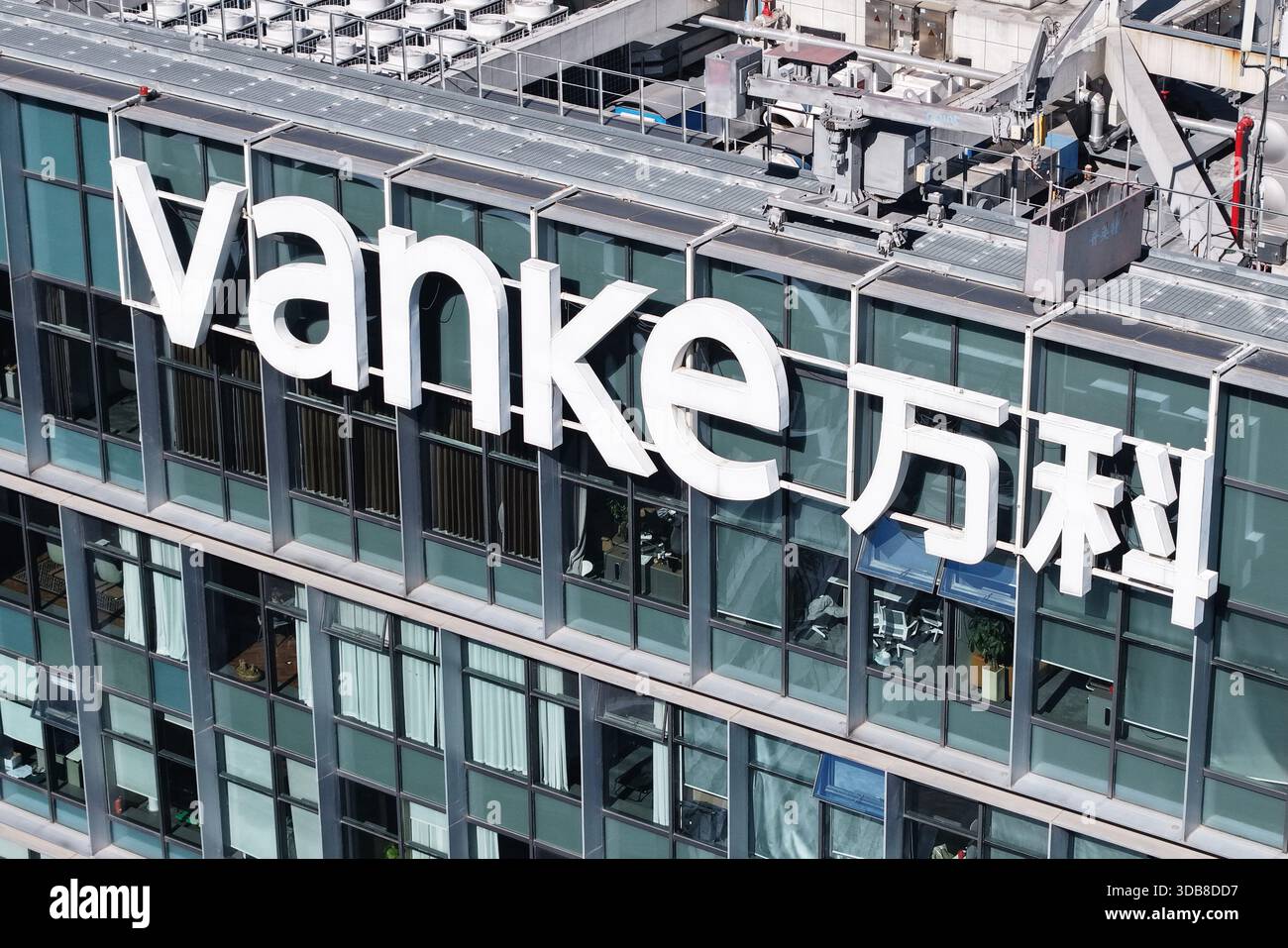 The logo of Vanke, a Shenzhen-based property developer, on top of an ...