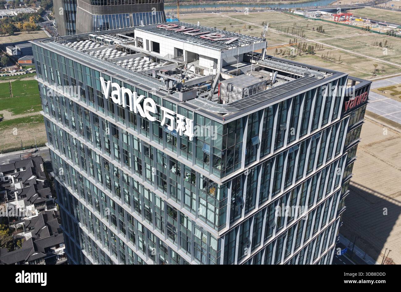 The logo of Vanke, a Shenzhen-based property developer, on top of an ...