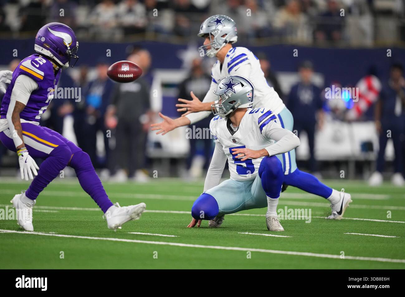Dallas Cowboys punter Bryan Anger, below right, looks on as place ...