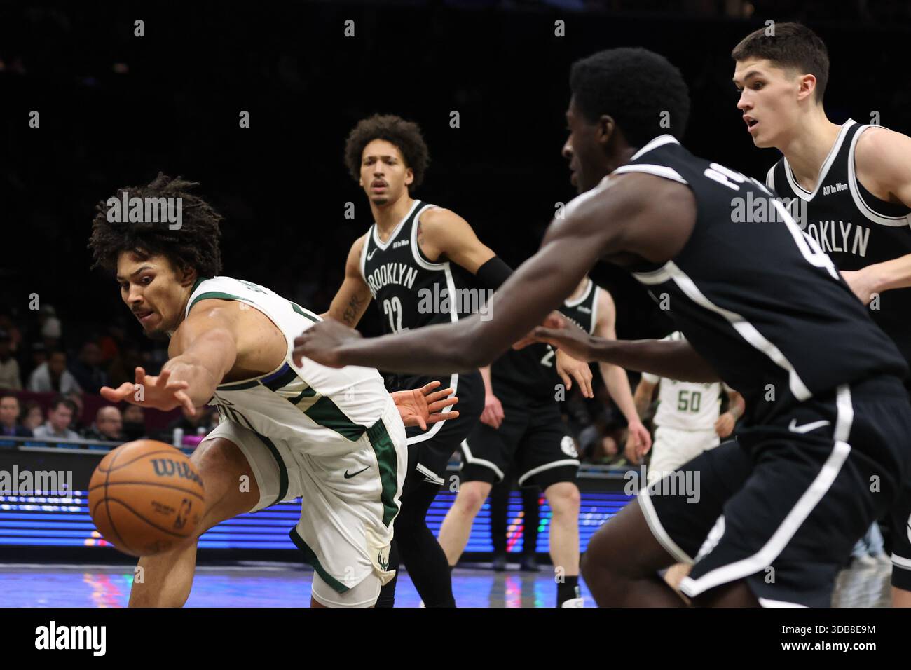 Milwaukee Bucks center Jericho Sims, left, reaches for the ball while ...