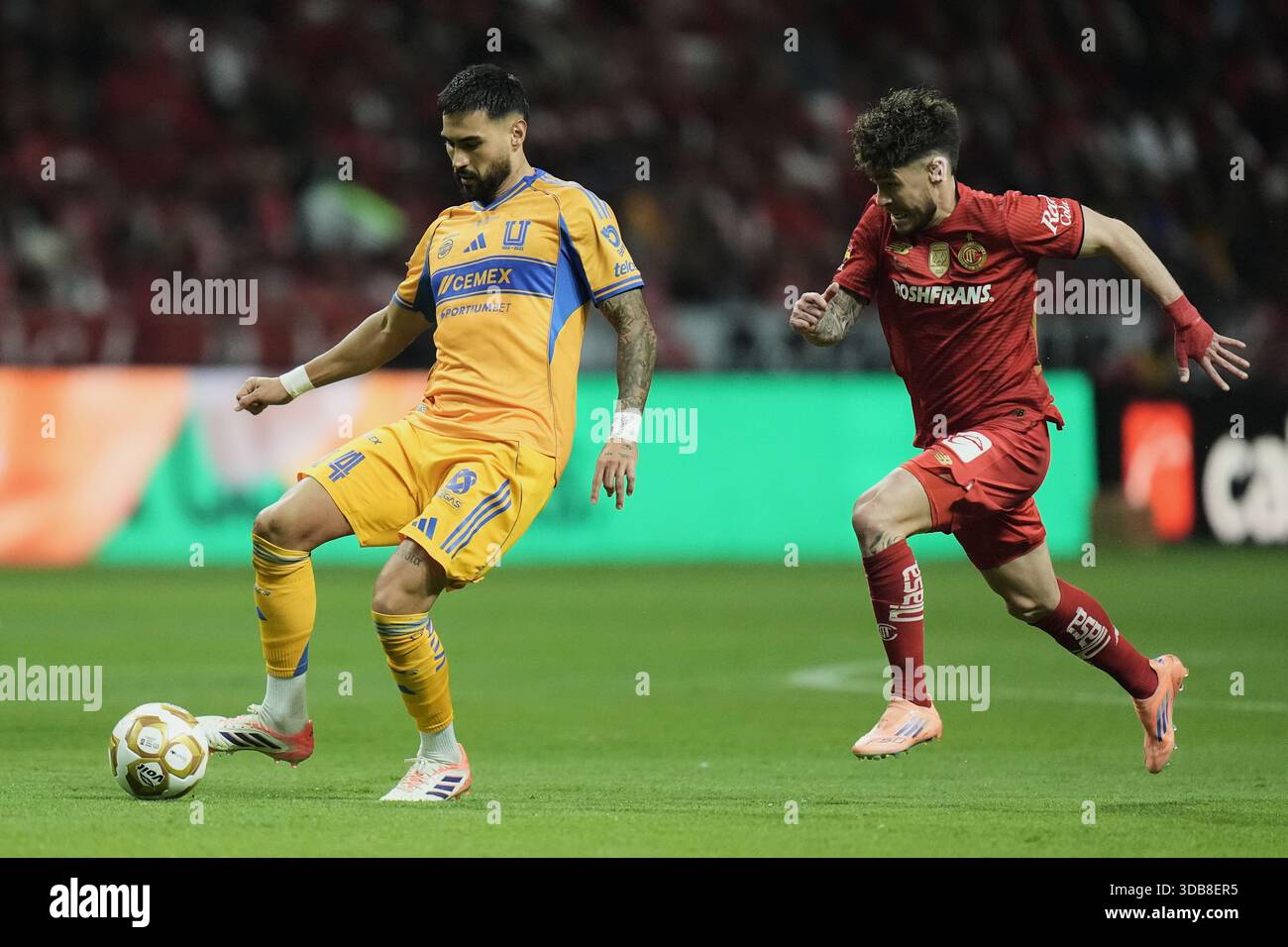 Toluca's Jesus Angulo, right, chases Tigres' Jesus Garza during the ...