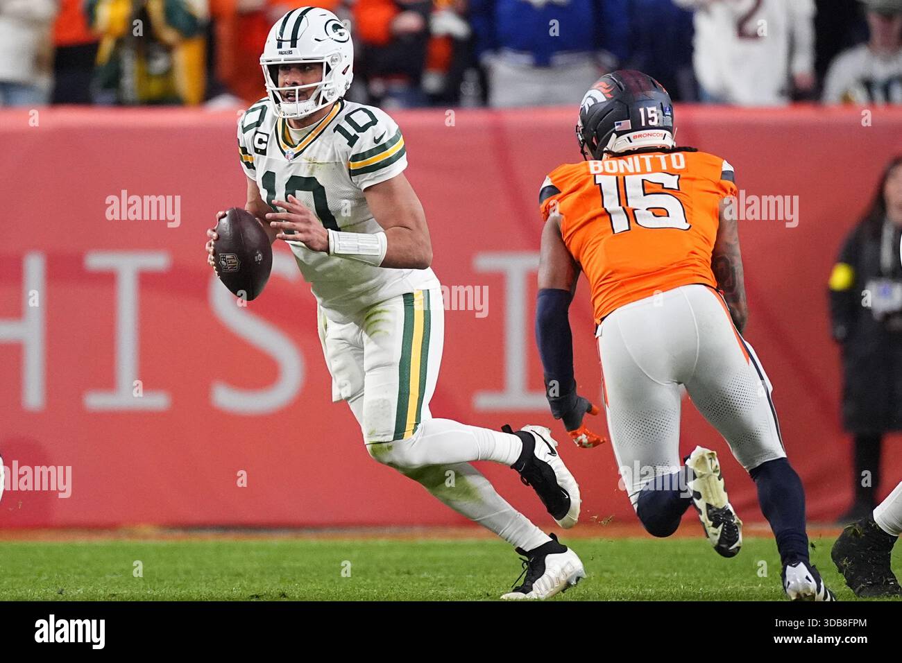 Green Bay Packers quarterback Jordan Love, left, evades Denver Broncos ...