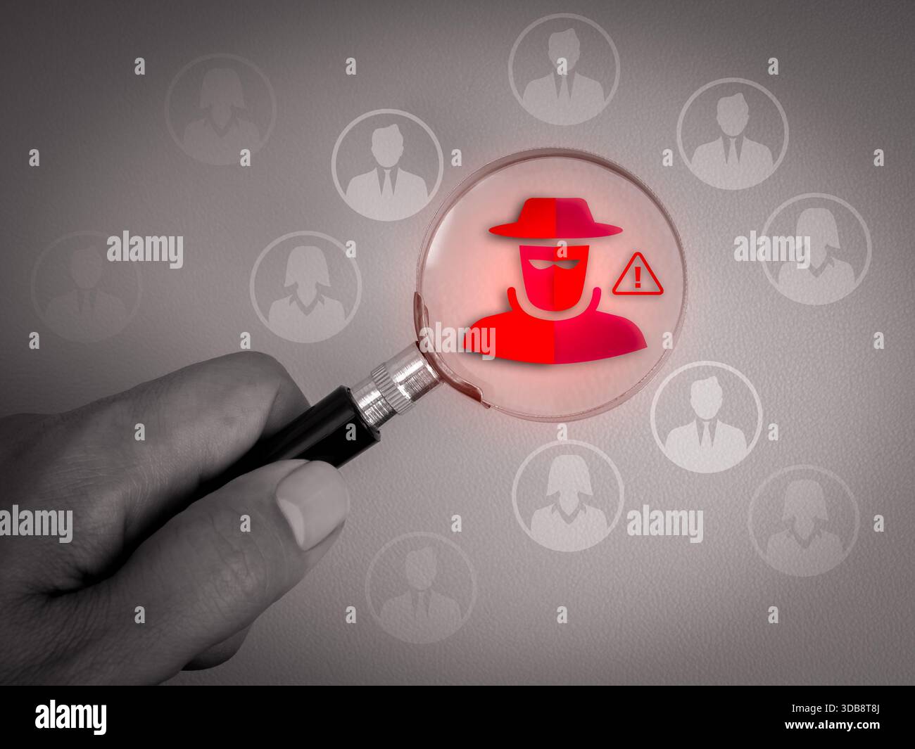 Hand holding magnifying glass highlighting red scammer icon with ...