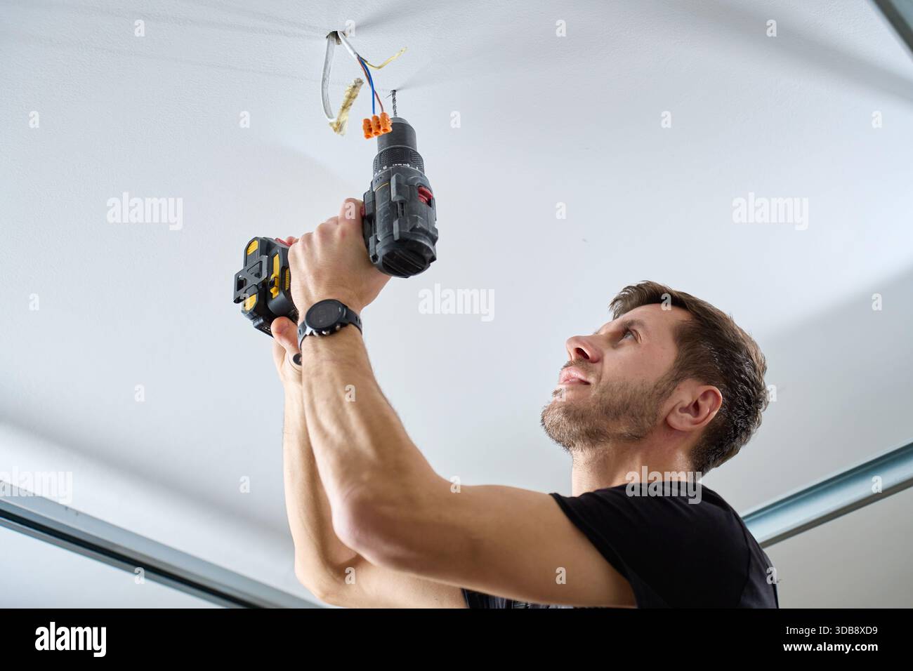 Man wearing work overalls drills hi-res stock photography and images ...