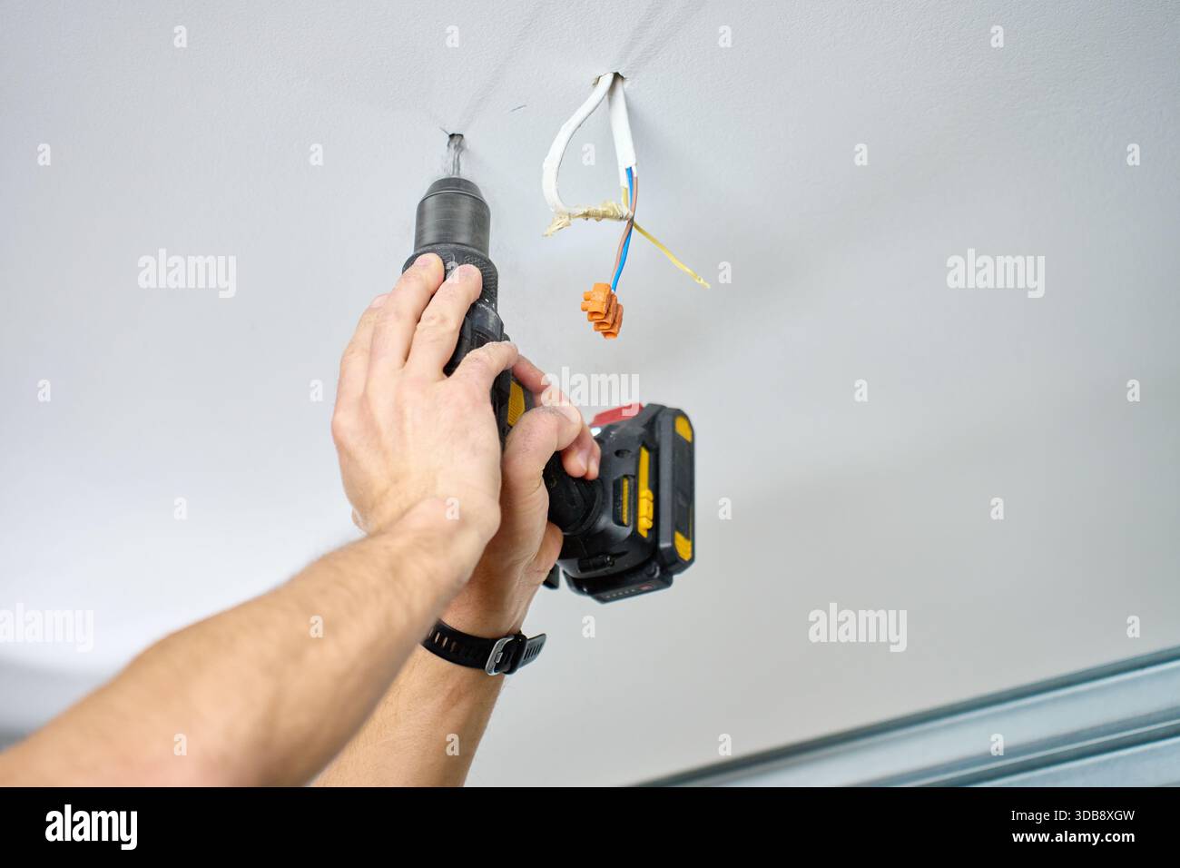 Man wearing work overalls drills hi-res stock photography and images ...