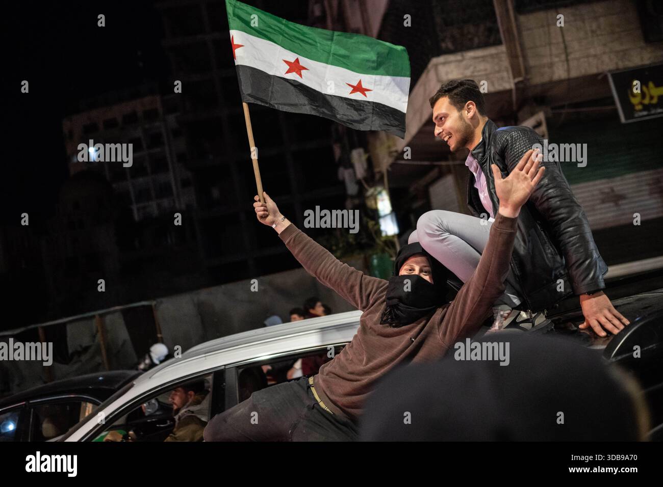 Damascus, Syria. December 7th 2025. Syrians waving flags and ...