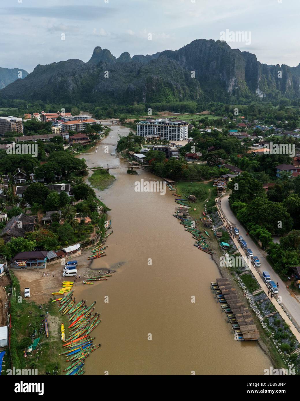 Aerial view of the muddy river weaving through the town, framed by ...