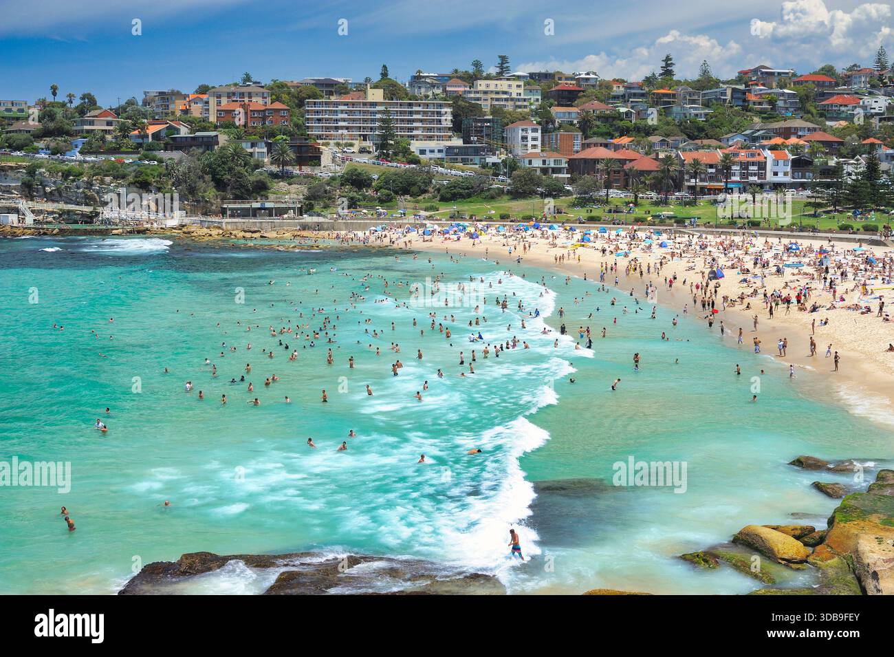 A beautiful view of Bondi Beach filled with sunbathers and swimmers ...