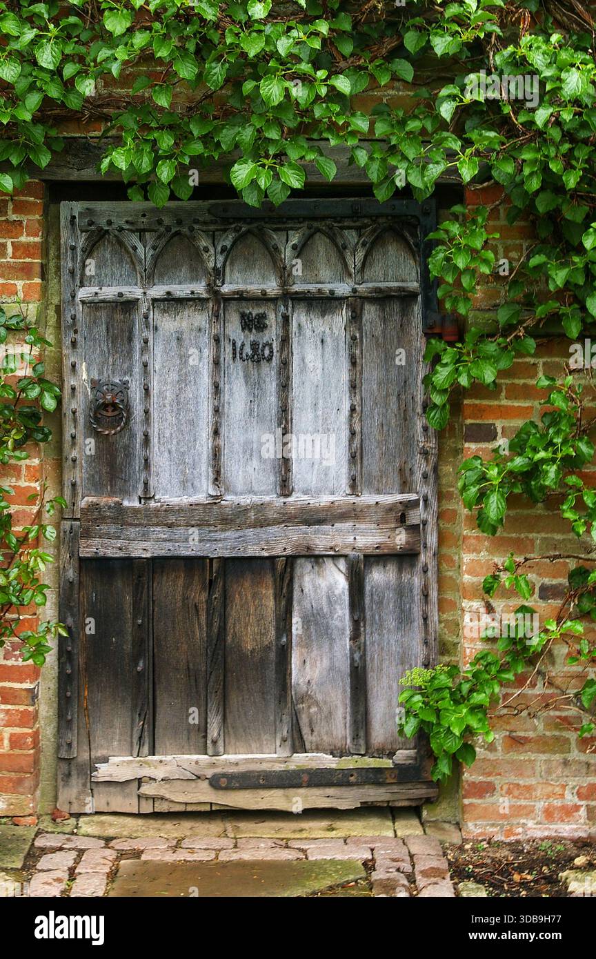 Old wooden door, marked with the date 1680, in the grounds of Kedleston ...
