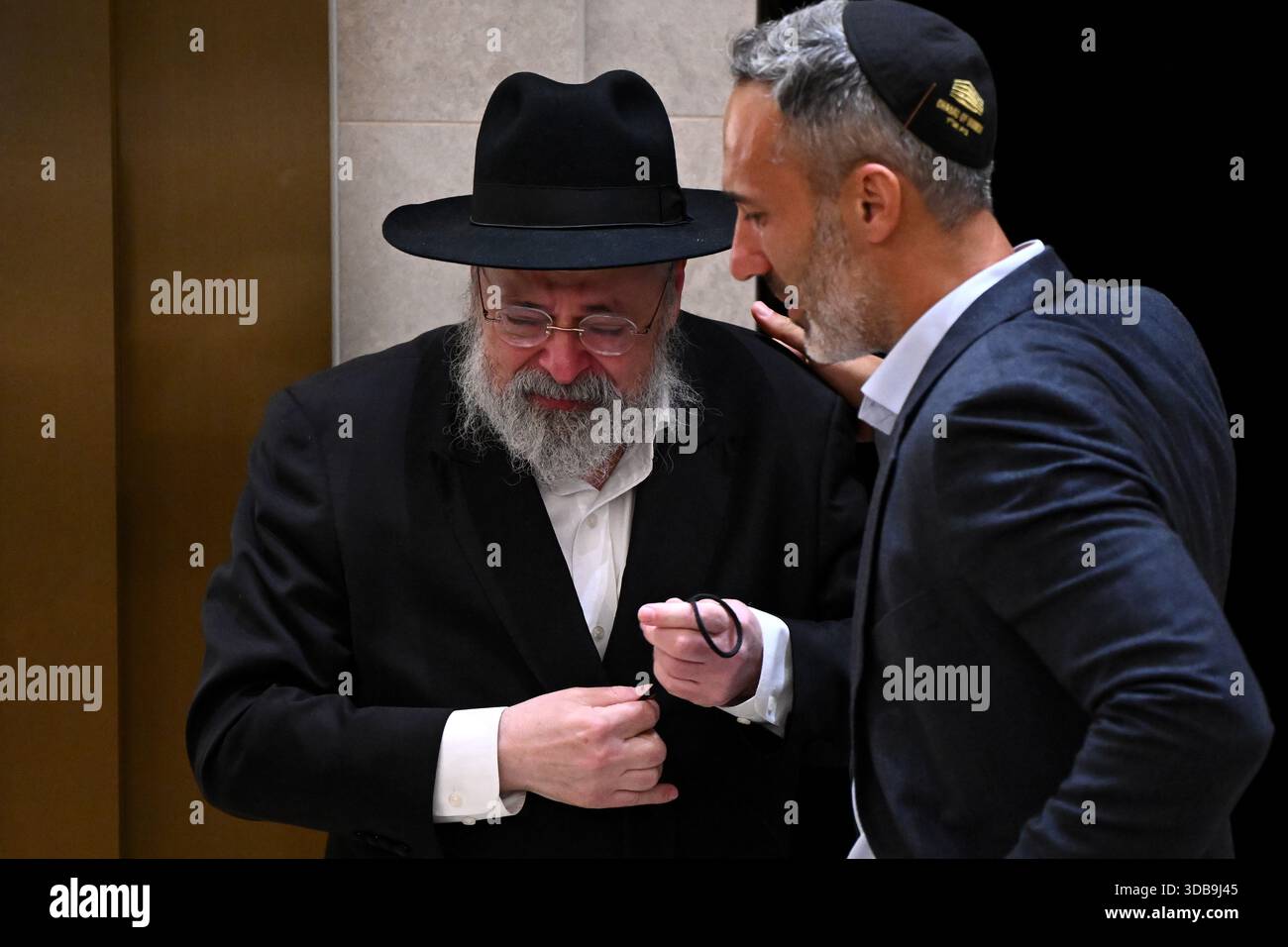 Sydney, Australia. 15th Dec, 2025. Rabbi Yehoram Ulman (left), father ...