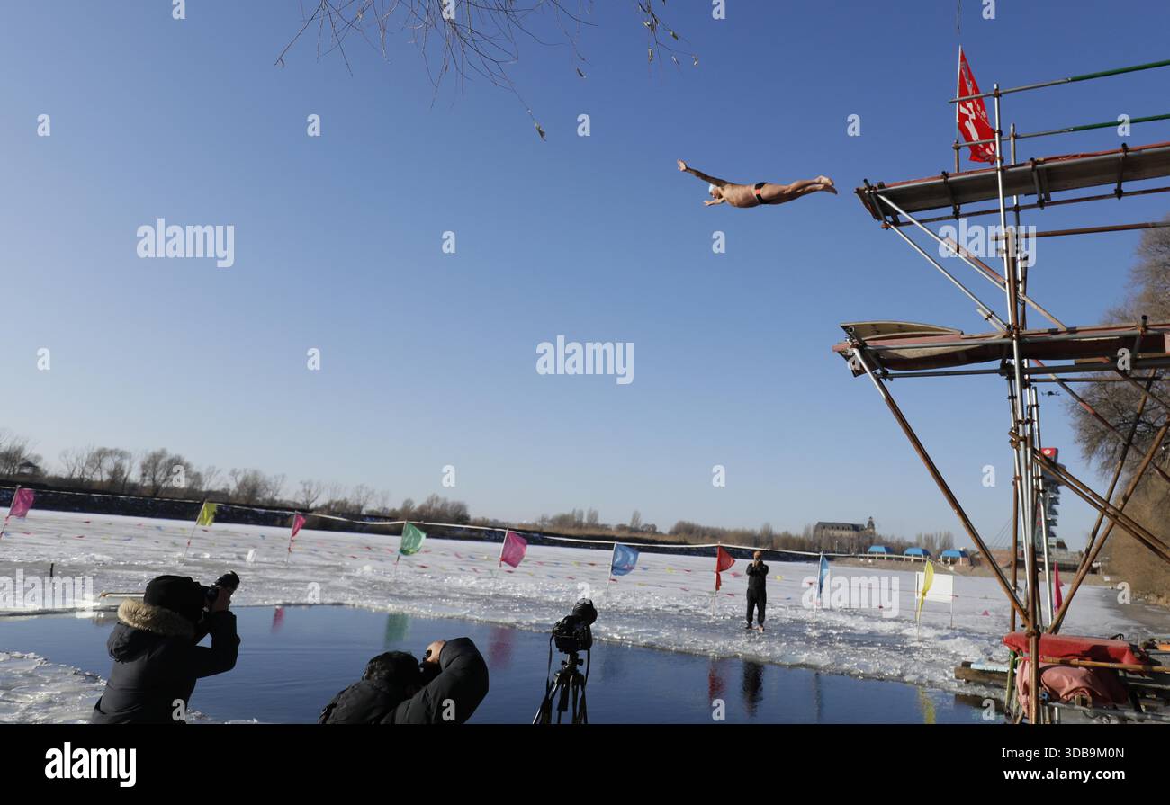 Winter swimming enthusiasts swim in the icy water in Harbin City ...