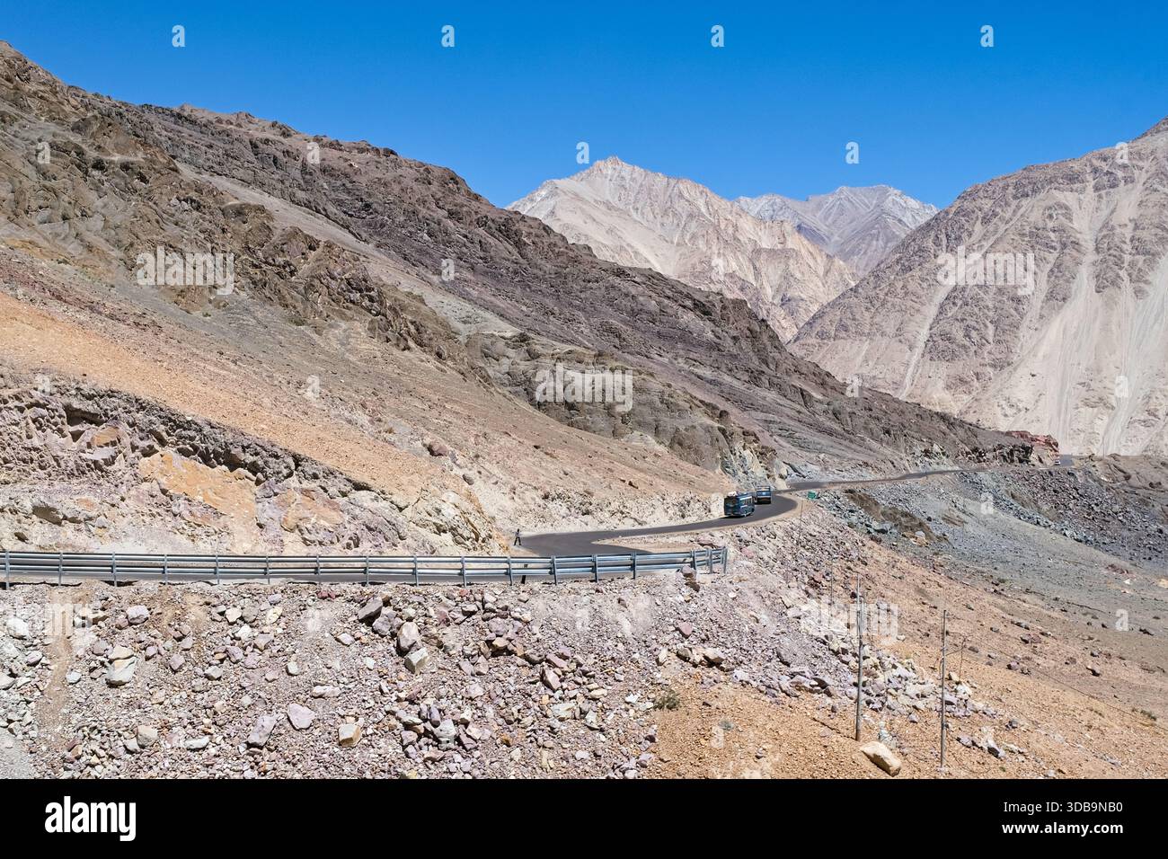 Vehicles driving along winding mountain road in Ladakh, northern India ...