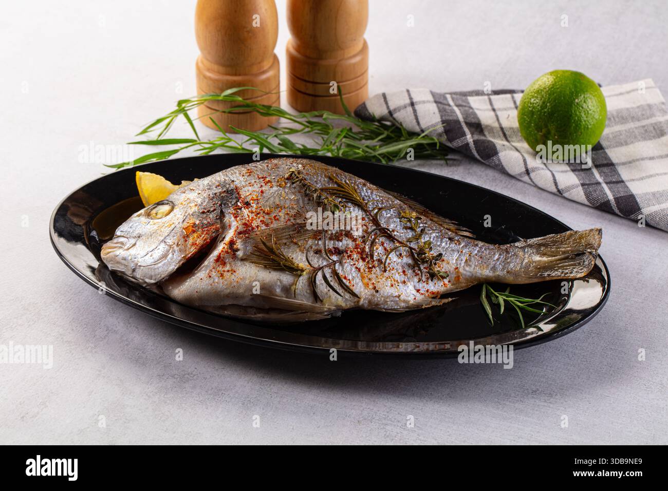 Baked dorada fish with spices and herbs Stock Photo - Alamy