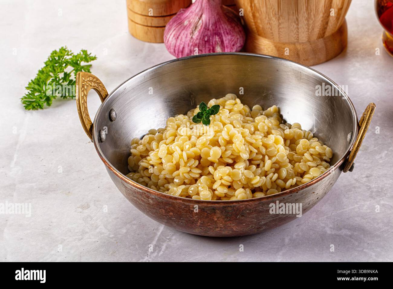 Boiled ptitim grain wheat pasta in the bowl Stock Photo - Alamy