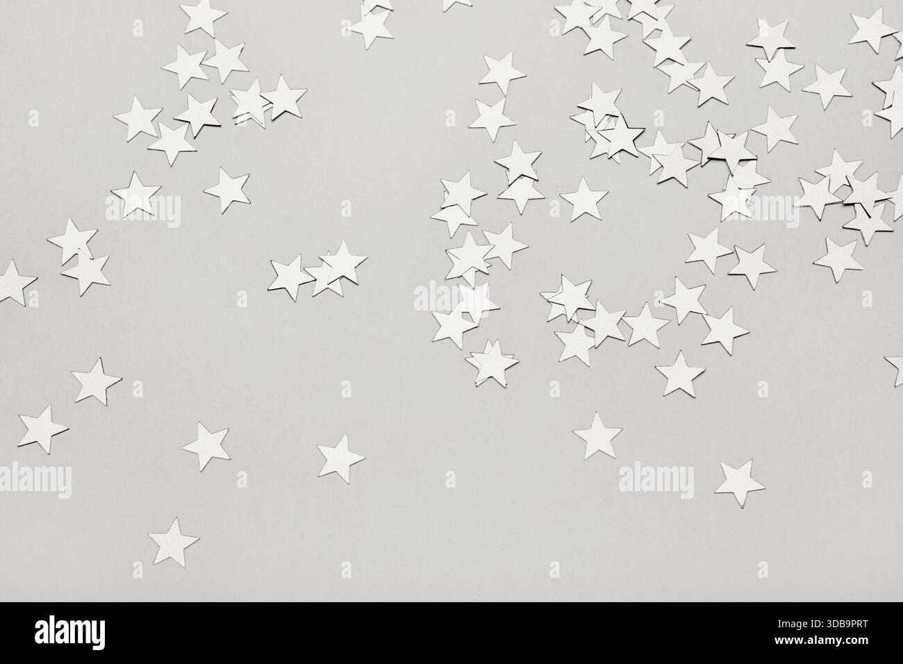 Cloud dancer colored star confetti sprinkling on a solid gray ...