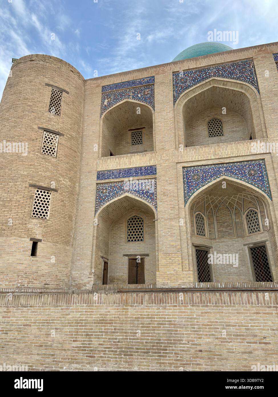 Brick facade, tiled arches, and dome of Mir-i-Arab Madrasah, Bukhara ...