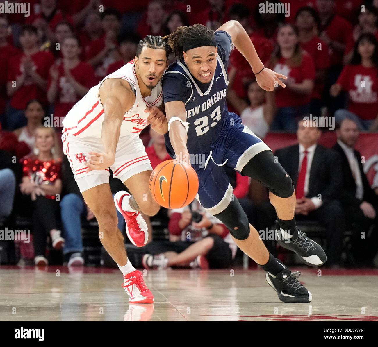 Houston guard Milos Uzan, left, battles for control of the ball against ...