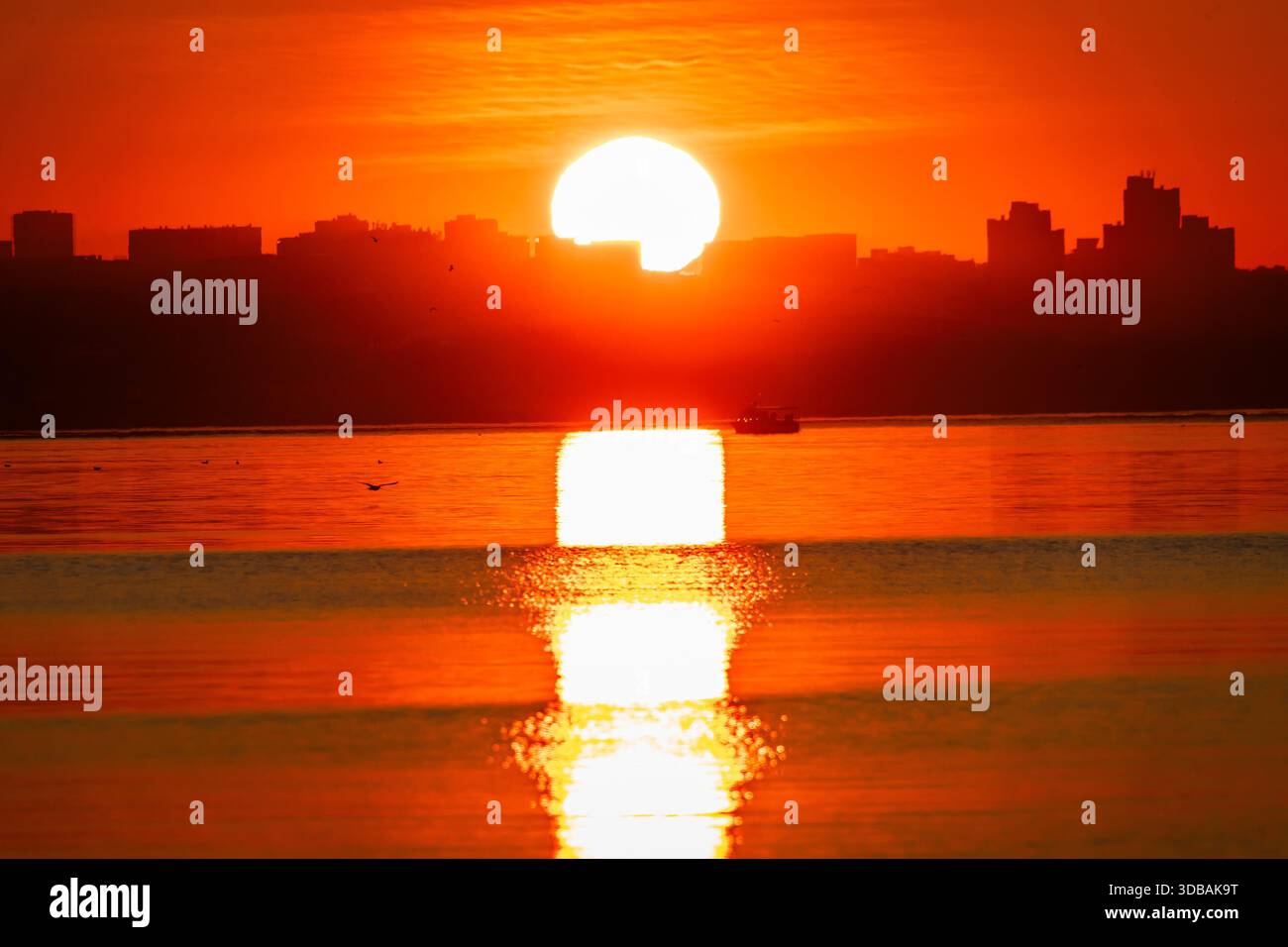 Sun Peaks Above Horizon while painting memorable sunrise over city of ...