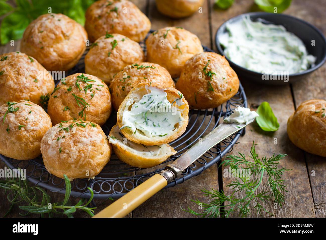 Gougeres with herb cream cheese. Traditional french cheese choux buns ...