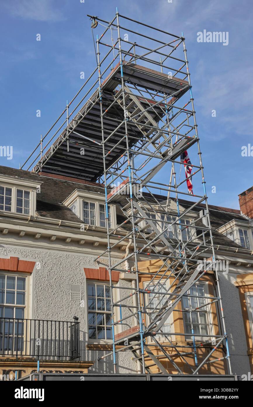 Scaffold tower and platform walkway on a building roof. England, UK ...