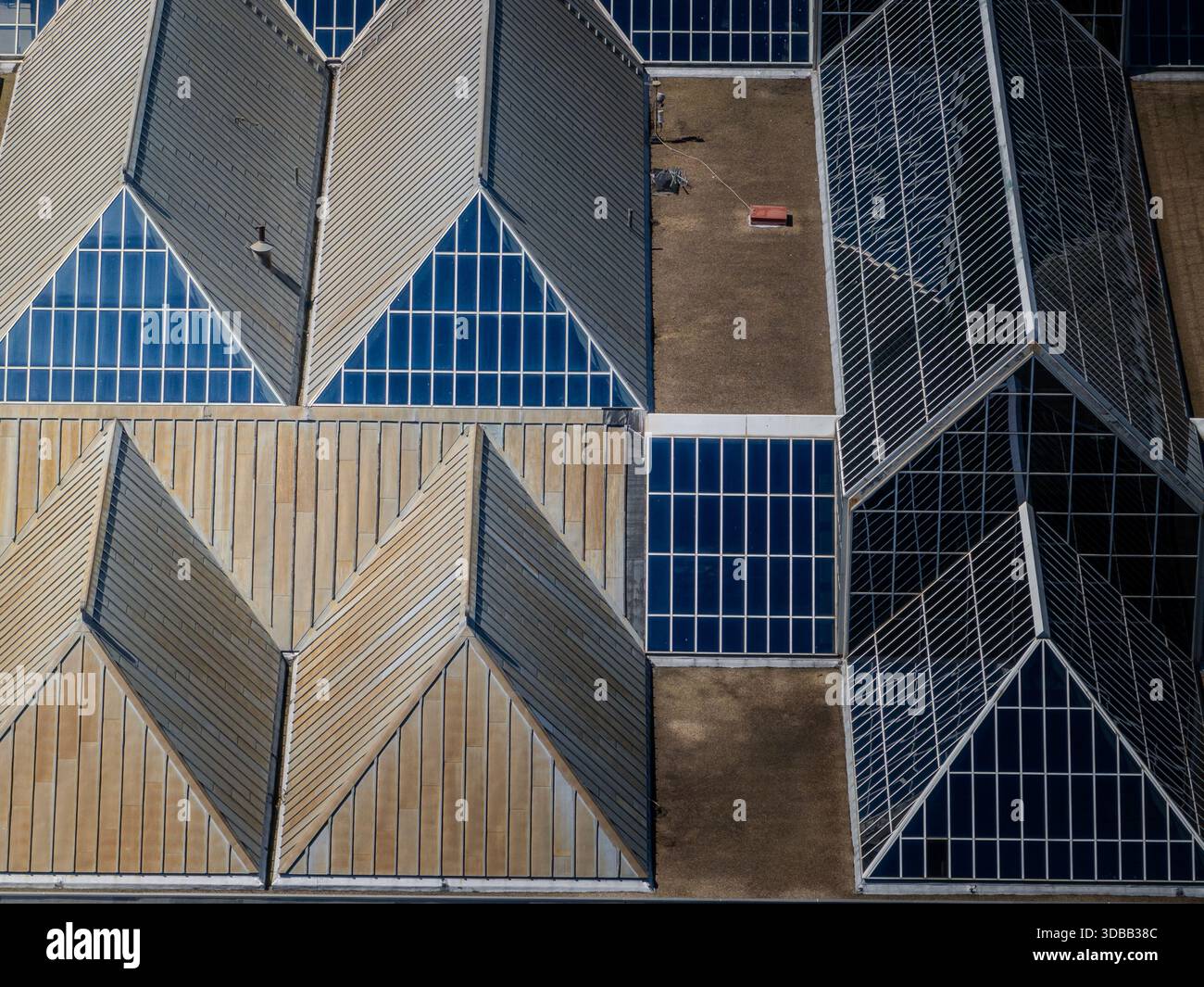 Aerial view of geometric glass roofs reflecting the sky, creating a ...