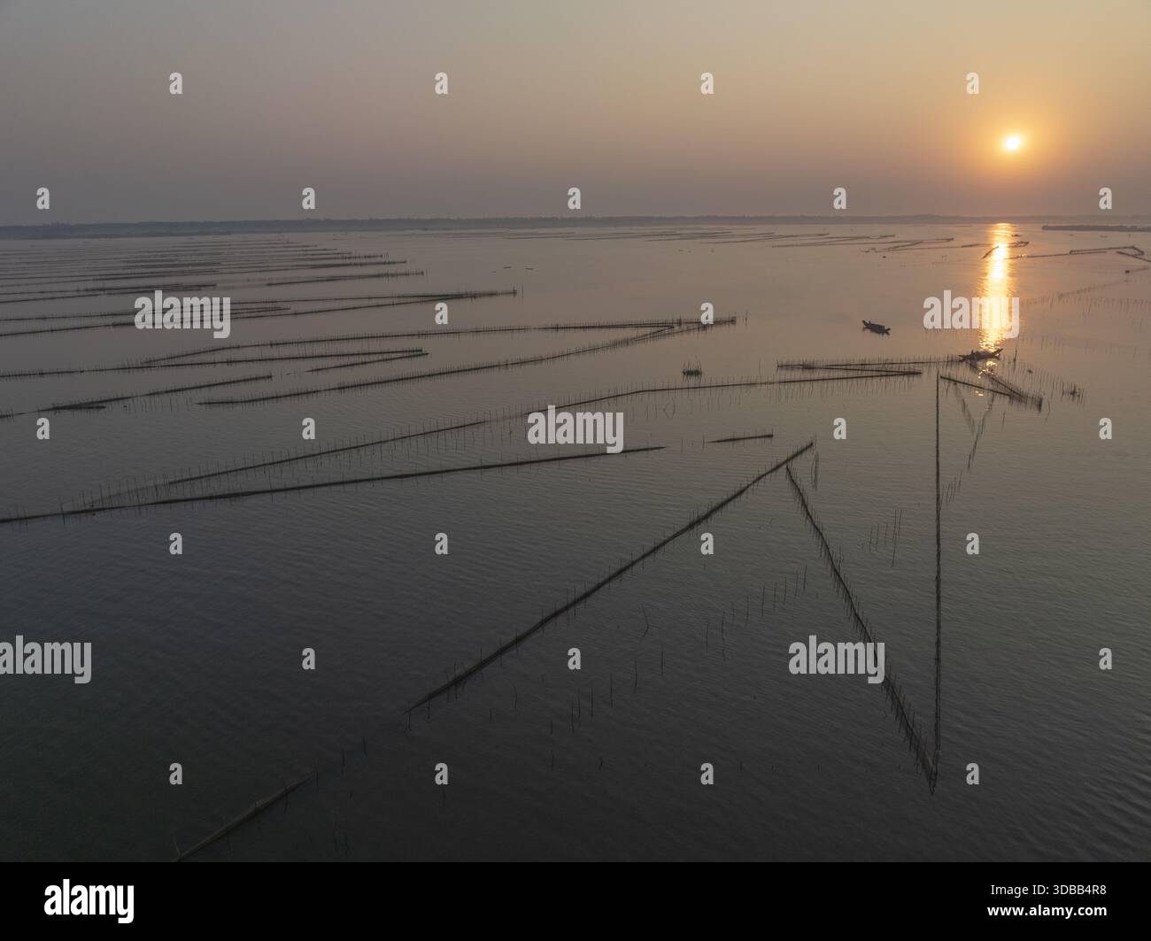 Aerial view of the glimmering sun reflecting off the tranquil waters ...